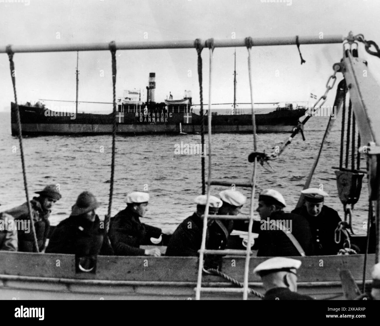 On board a German destroyer, a cutter is made ready for sailors to sail ...