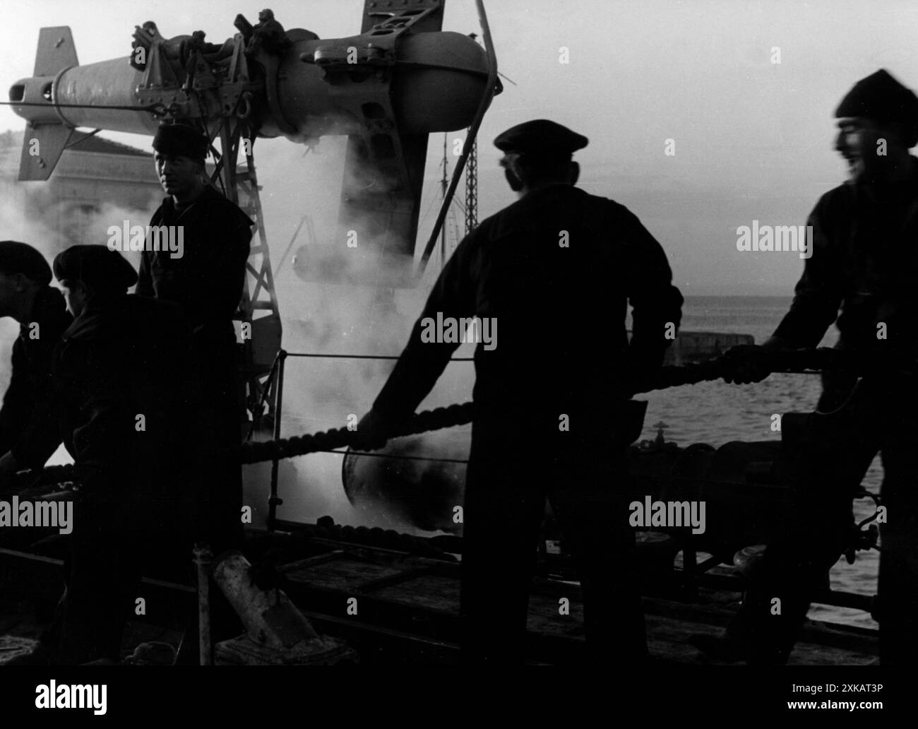 Sailors on board a Kriegsmarine minesweeper. An otter device in the ...