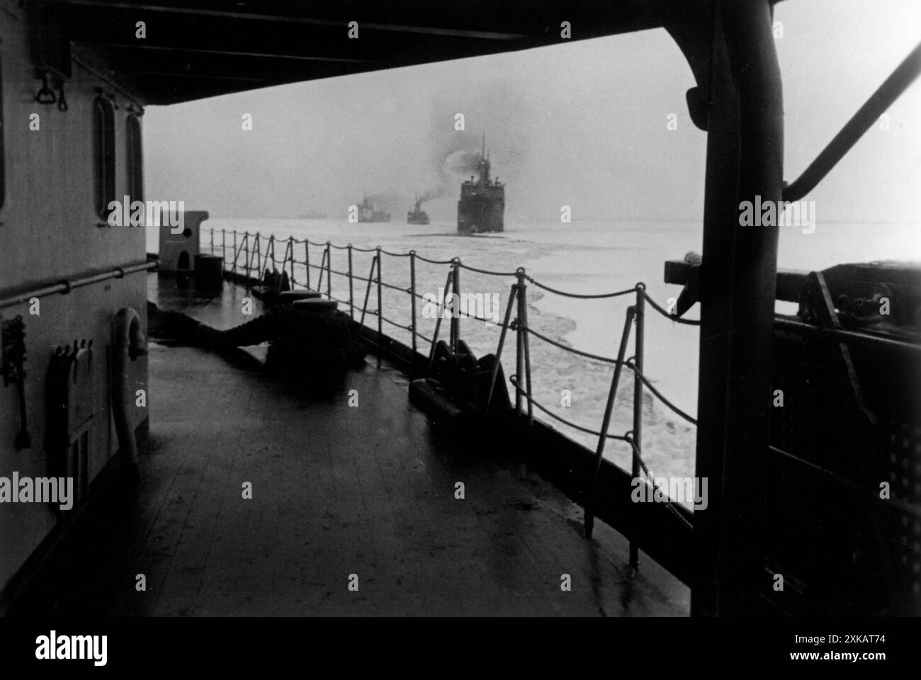 An icebreaker creates an ice-free channel for the ships of a convoy ...