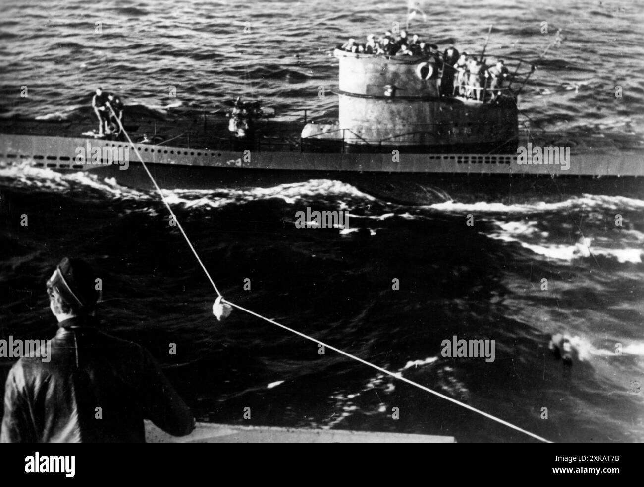 An outpost boat hands a mail bag to U 751 Type VII C (Captain ...