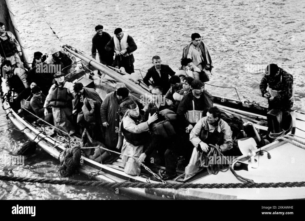A lifeboat with members of sunken ships on a German warship. [automated ...