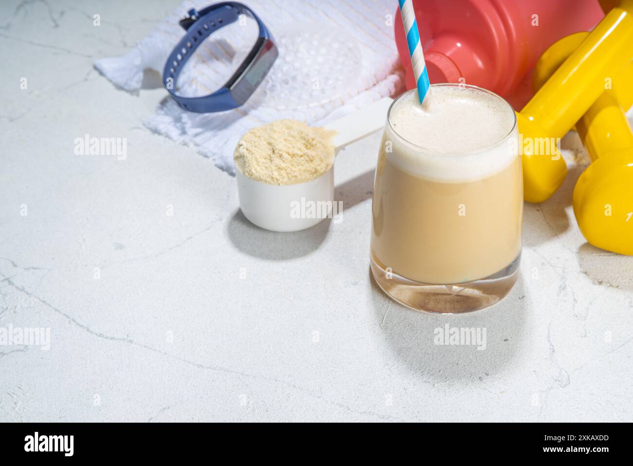 Vanilla white protein shake glass, with straw, with protein powder ...