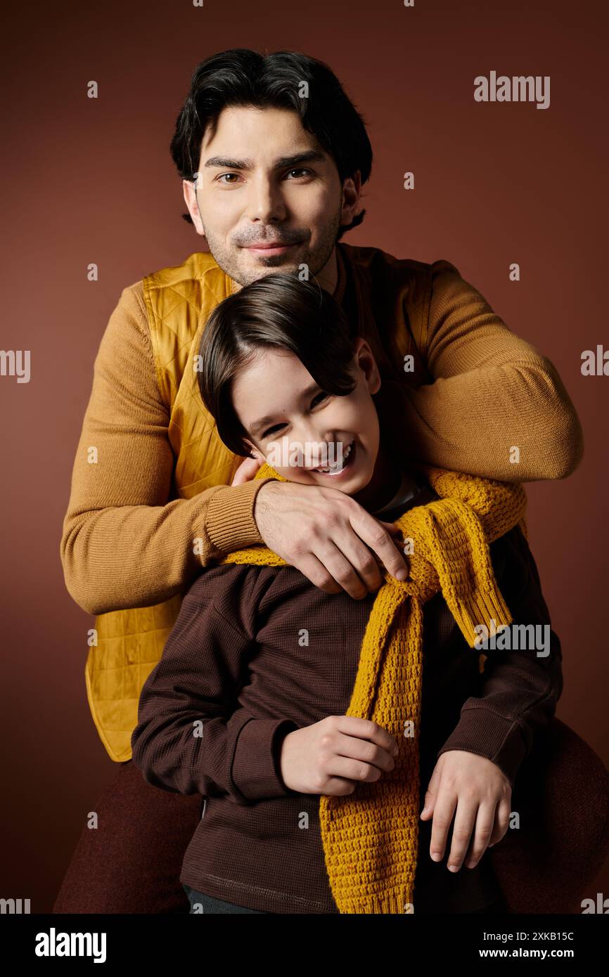 A father and his son share a warm embrace, laughing together in a ...