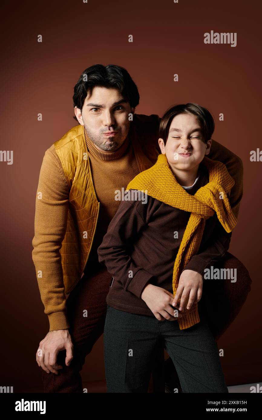 A father and his son pose together, both making silly faces Stock Photo ...