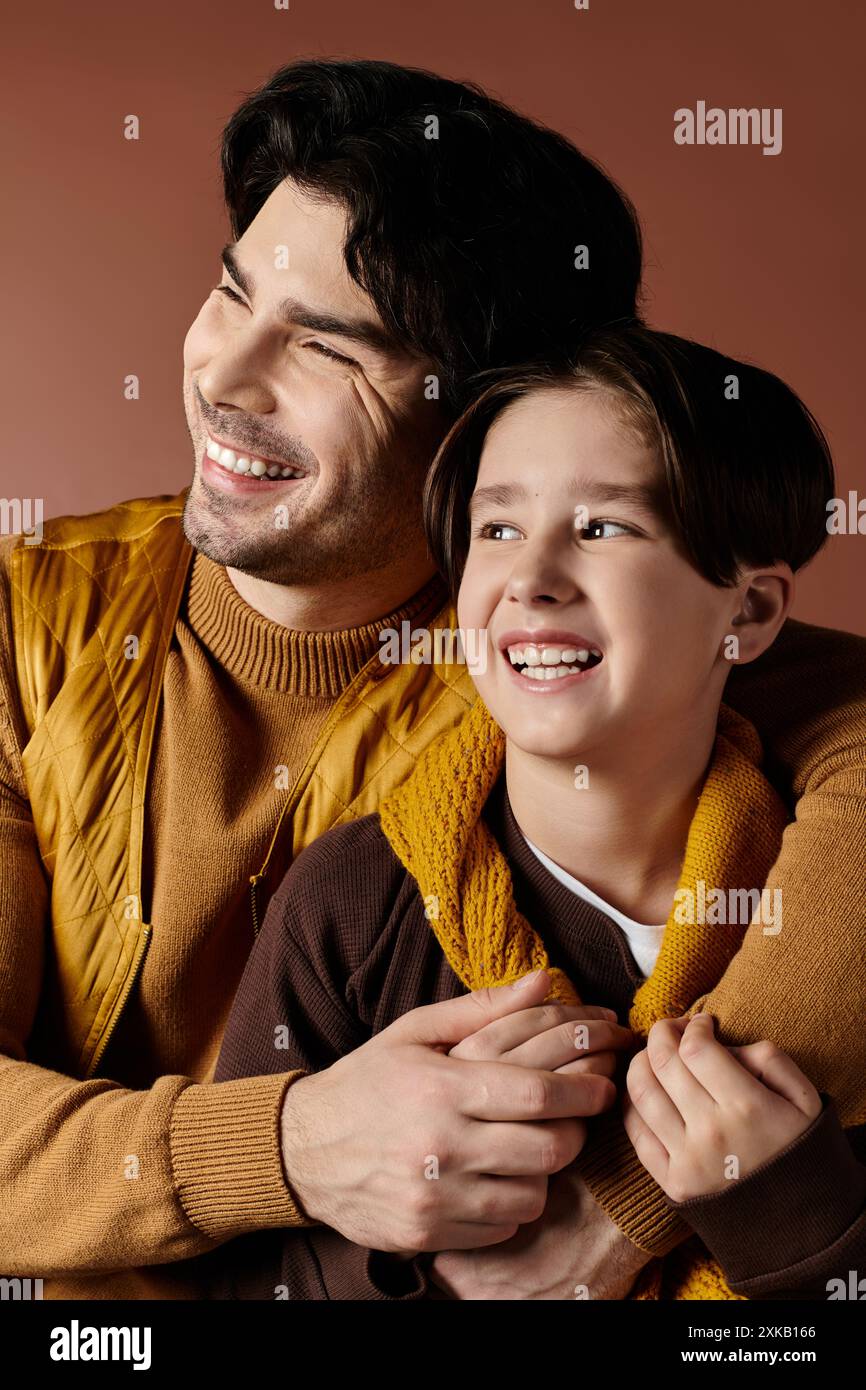 A father and son embrace, smiling and laughing together Stock Photo - Alamy