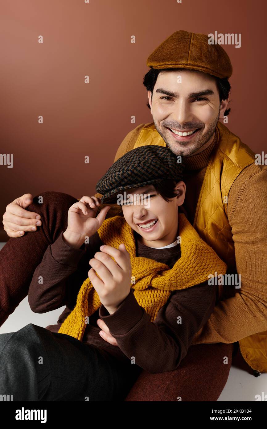 A father and son share a moment of laughter and affection, wearing ...