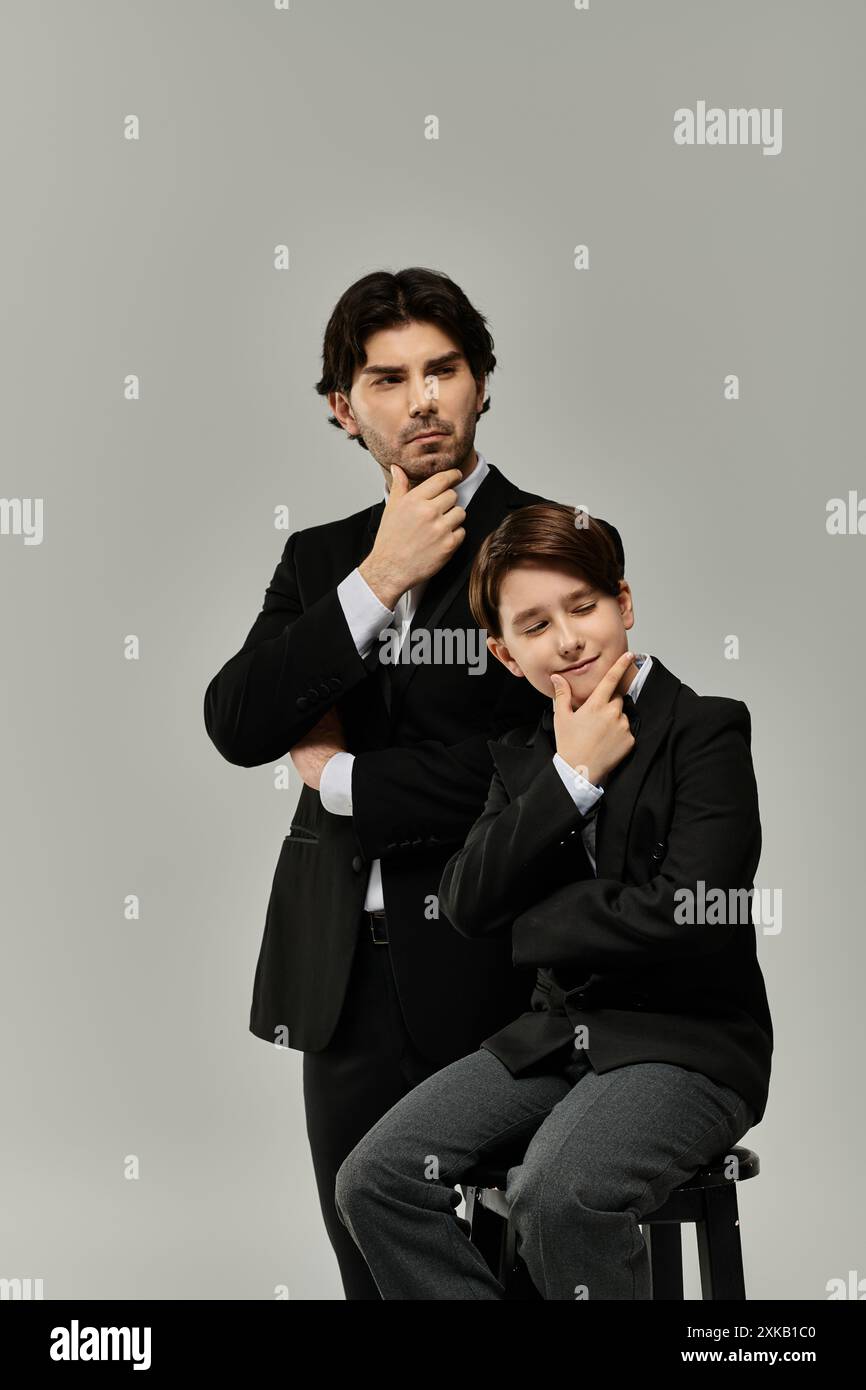 A father and son, both in suits, stand side by side, thoughtfully ...