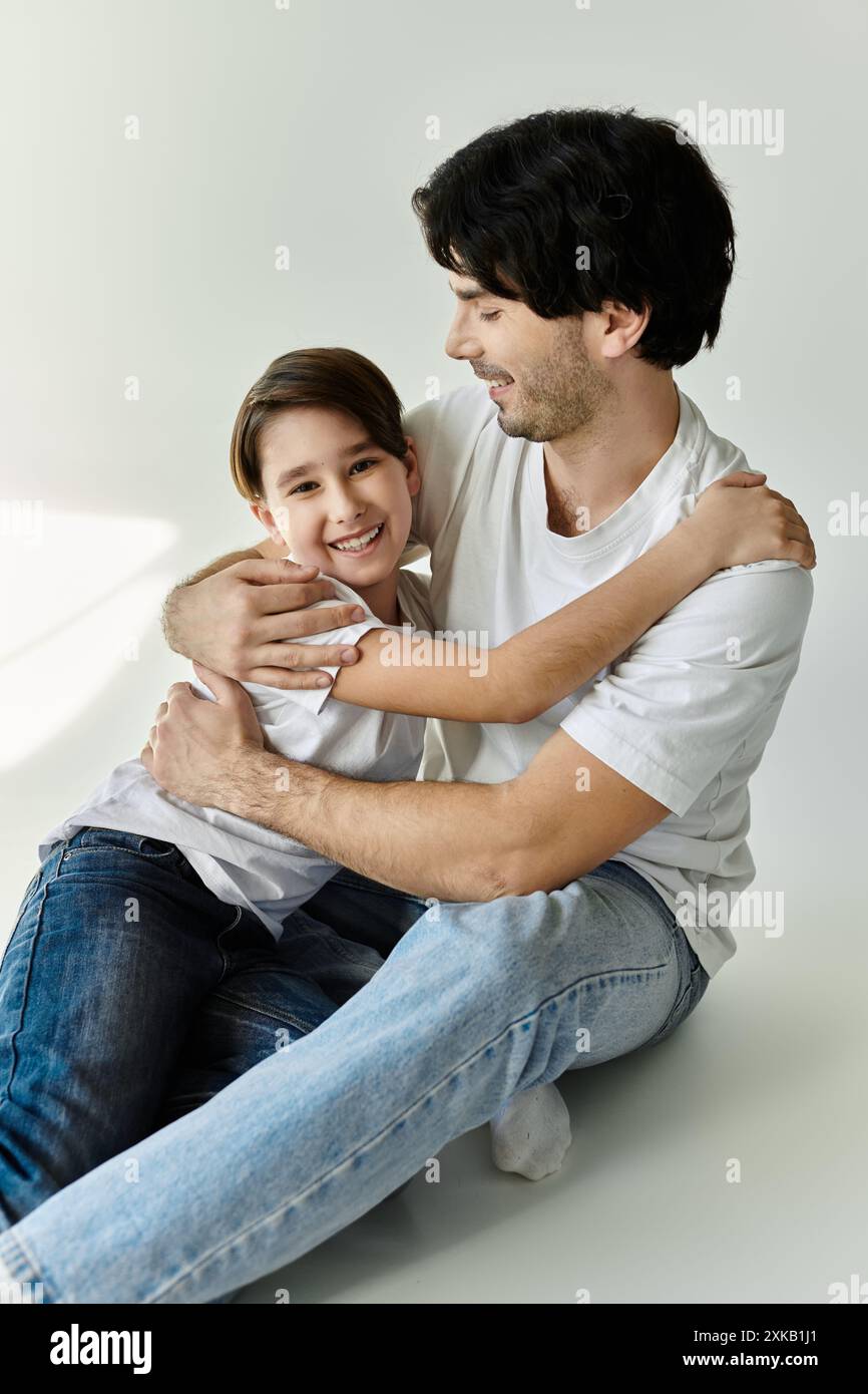 A father and son embrace, sharing a happy moment together Stock Photo ...