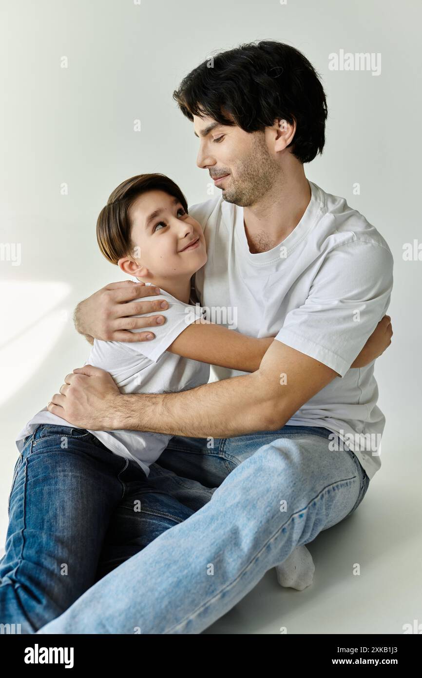 A father and son share a tender moment of affection, their eyes locked ...