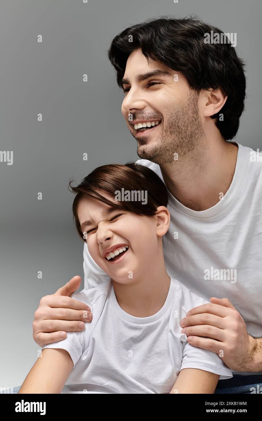 A father and son share a joyous laugh together Stock Photo - Alamy