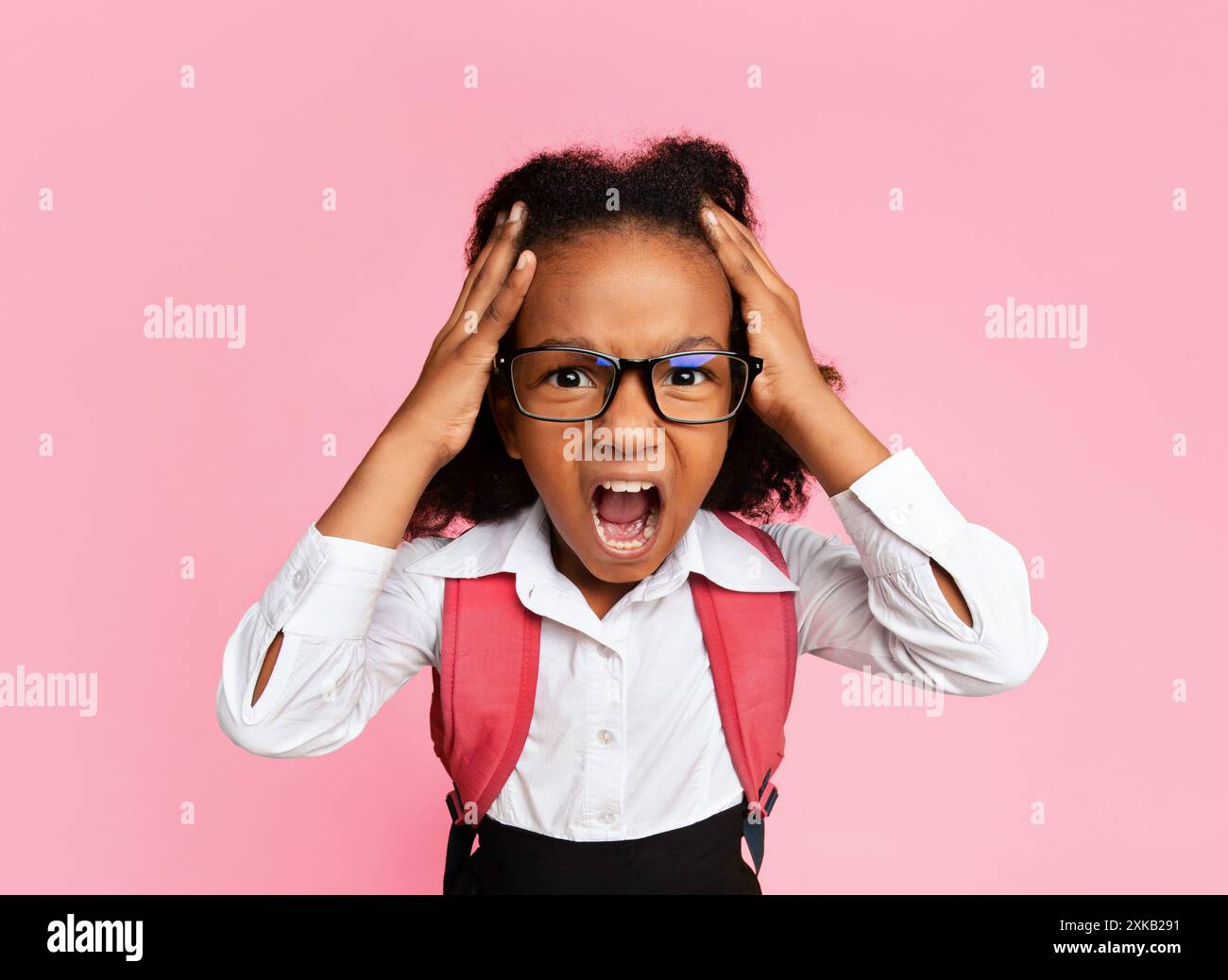 Stressed Black Schoolgirl Shouting Touching Head In Studio, Vertical ...