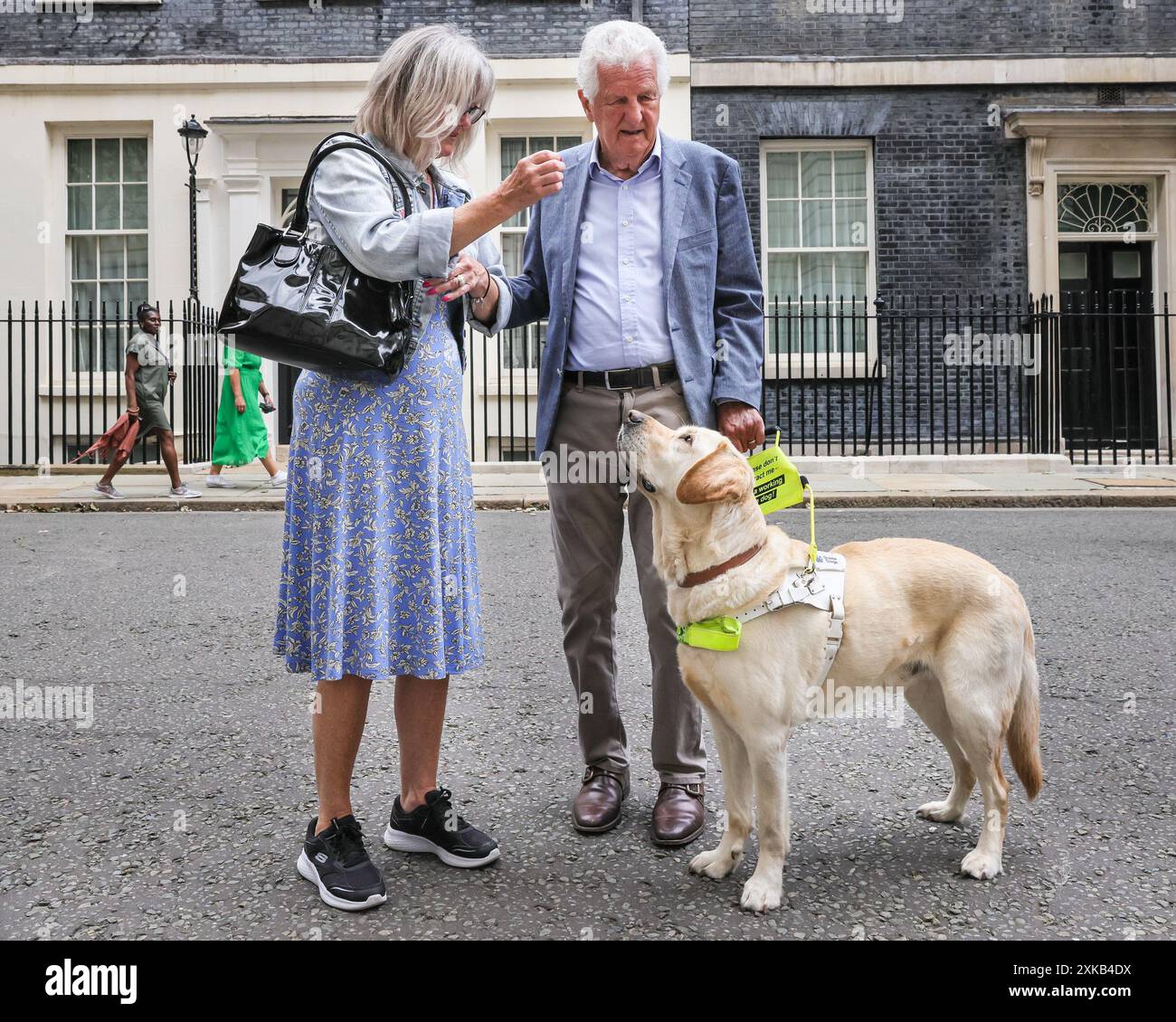 London, 22st July 2024. David Adams with guide dog Jimbo and a ...