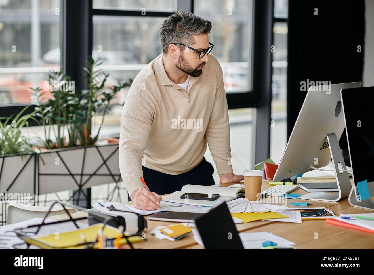 Businessman beard works desk hi-res stock photography and images - Alamy
