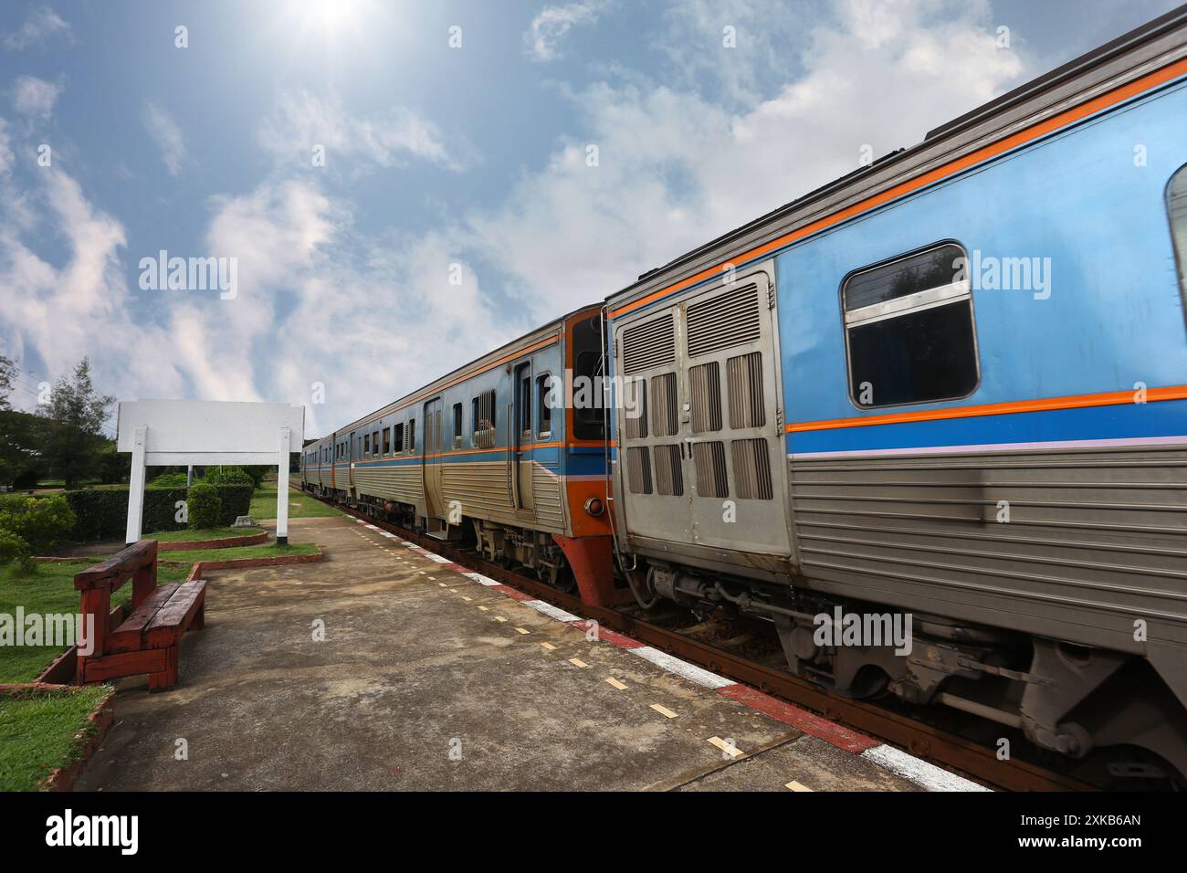The train was approaching the station, the tracks were lined with trees ...