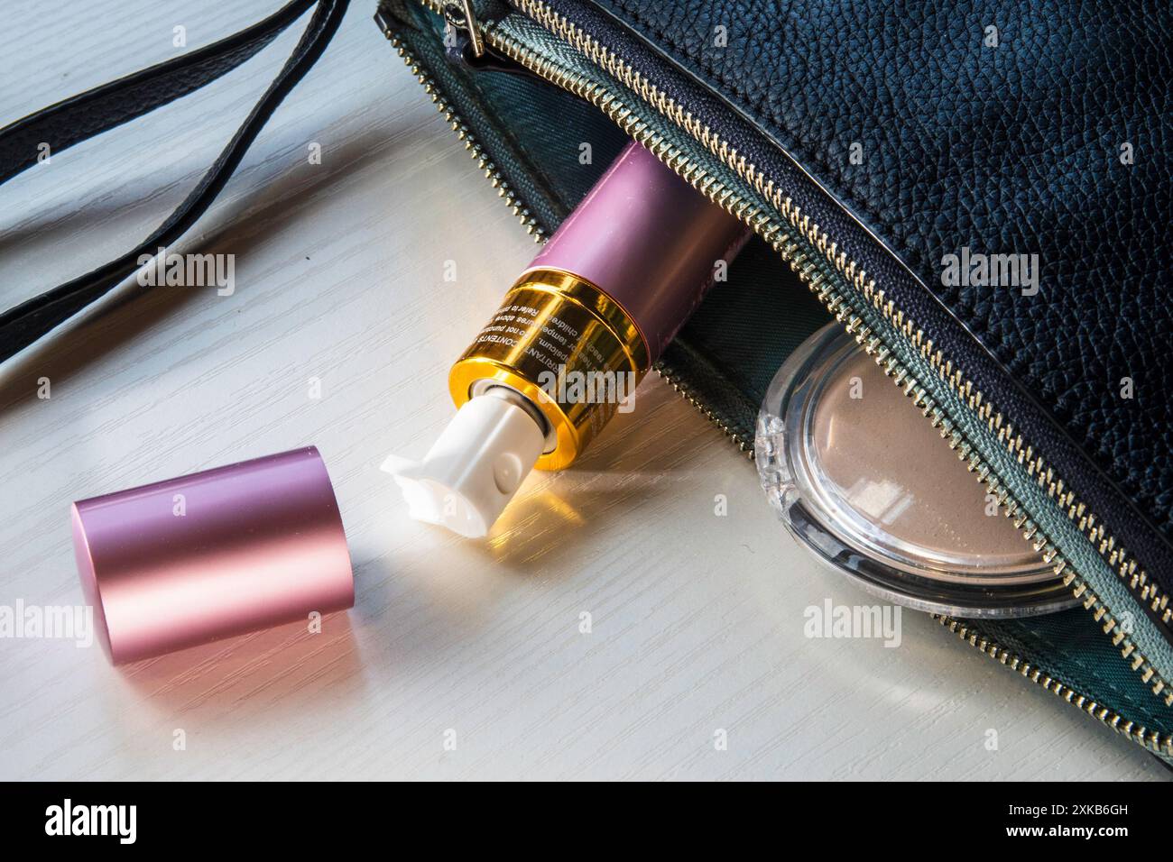 Still life of a feminine pink pepper spray dispenser in a woman's purse ...