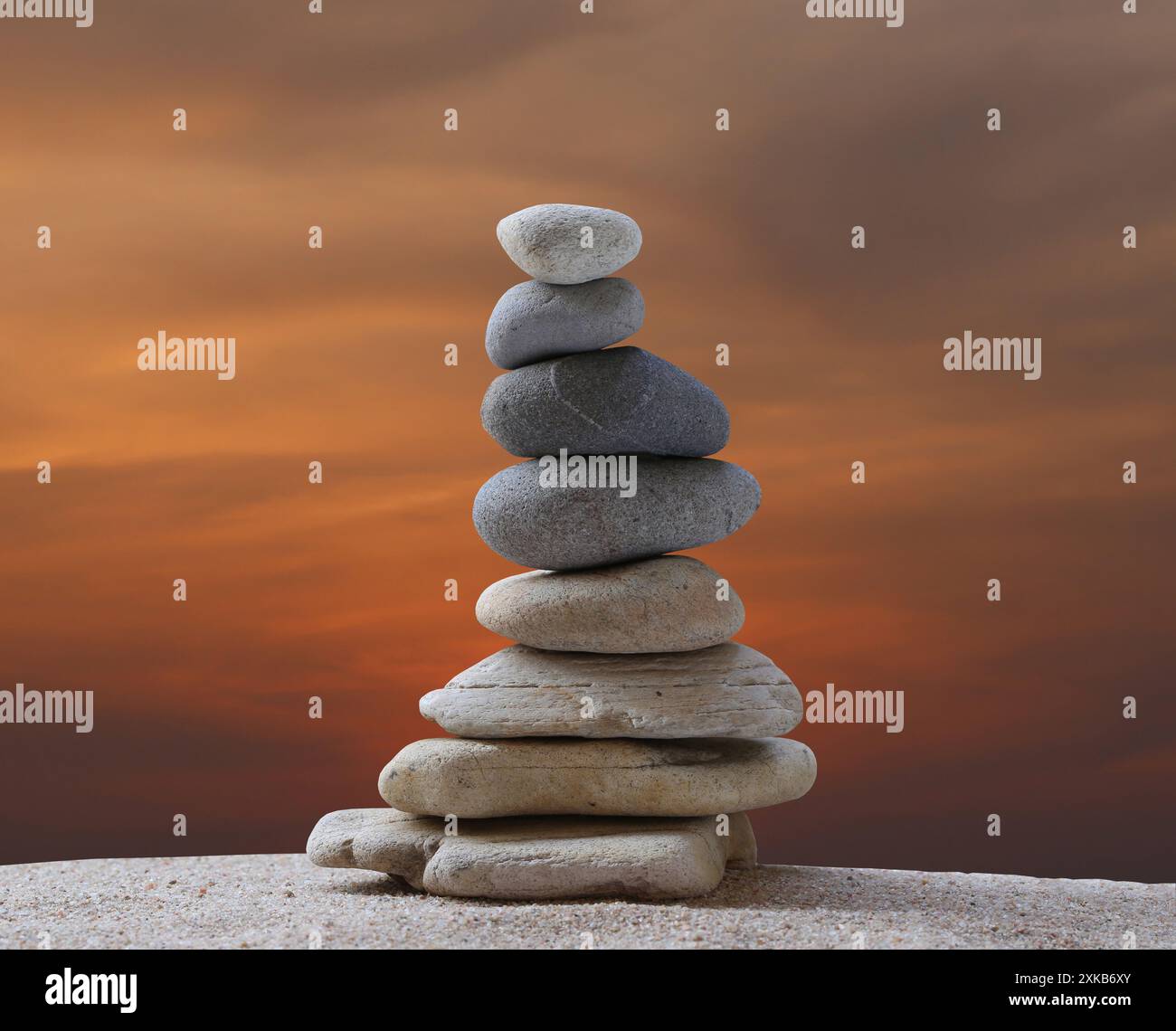 Stacked stones in a pyramid shape on a background on sunset and copy ...