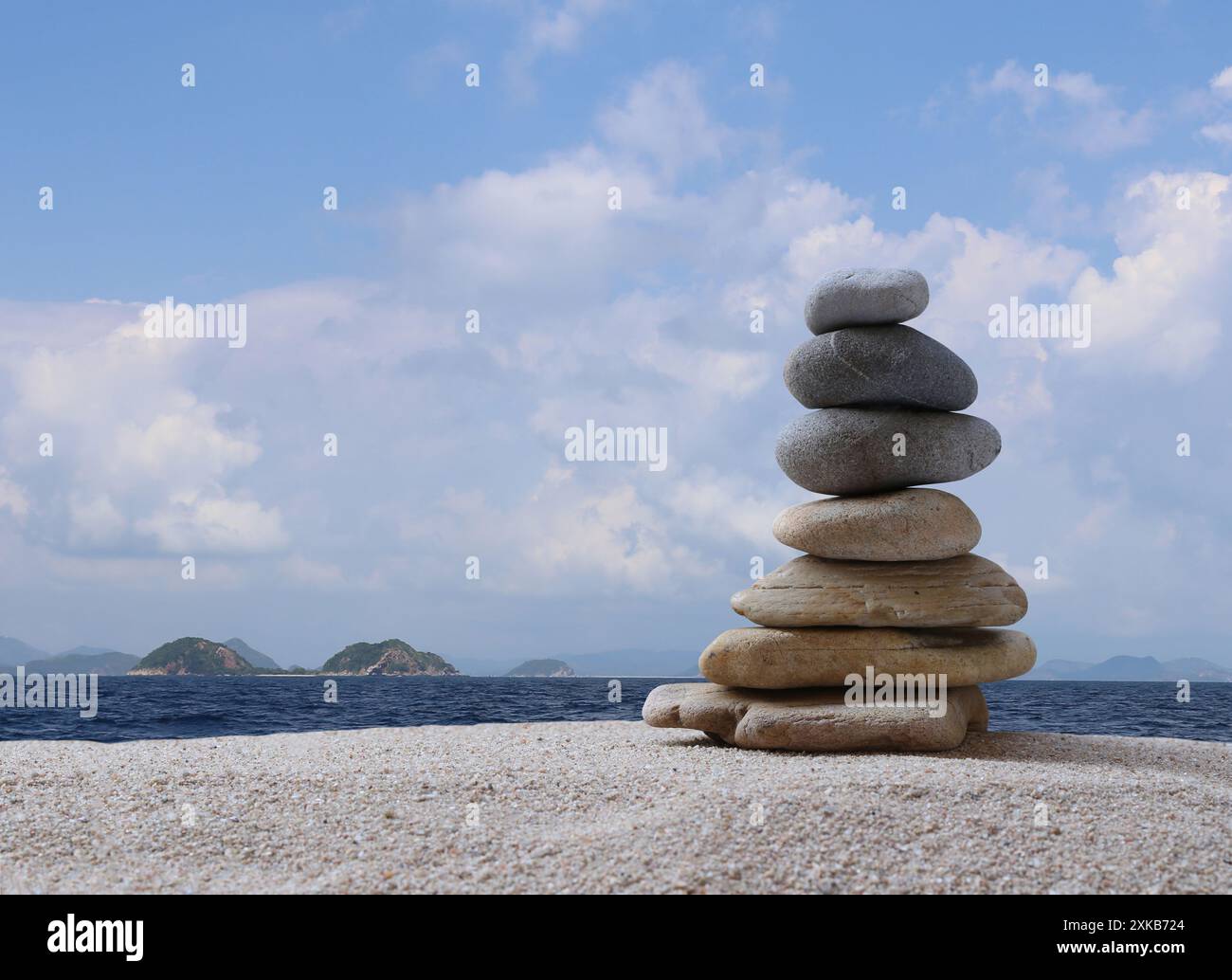 Sandstone are stacked into a pyramid shape on sea and cloud background ...