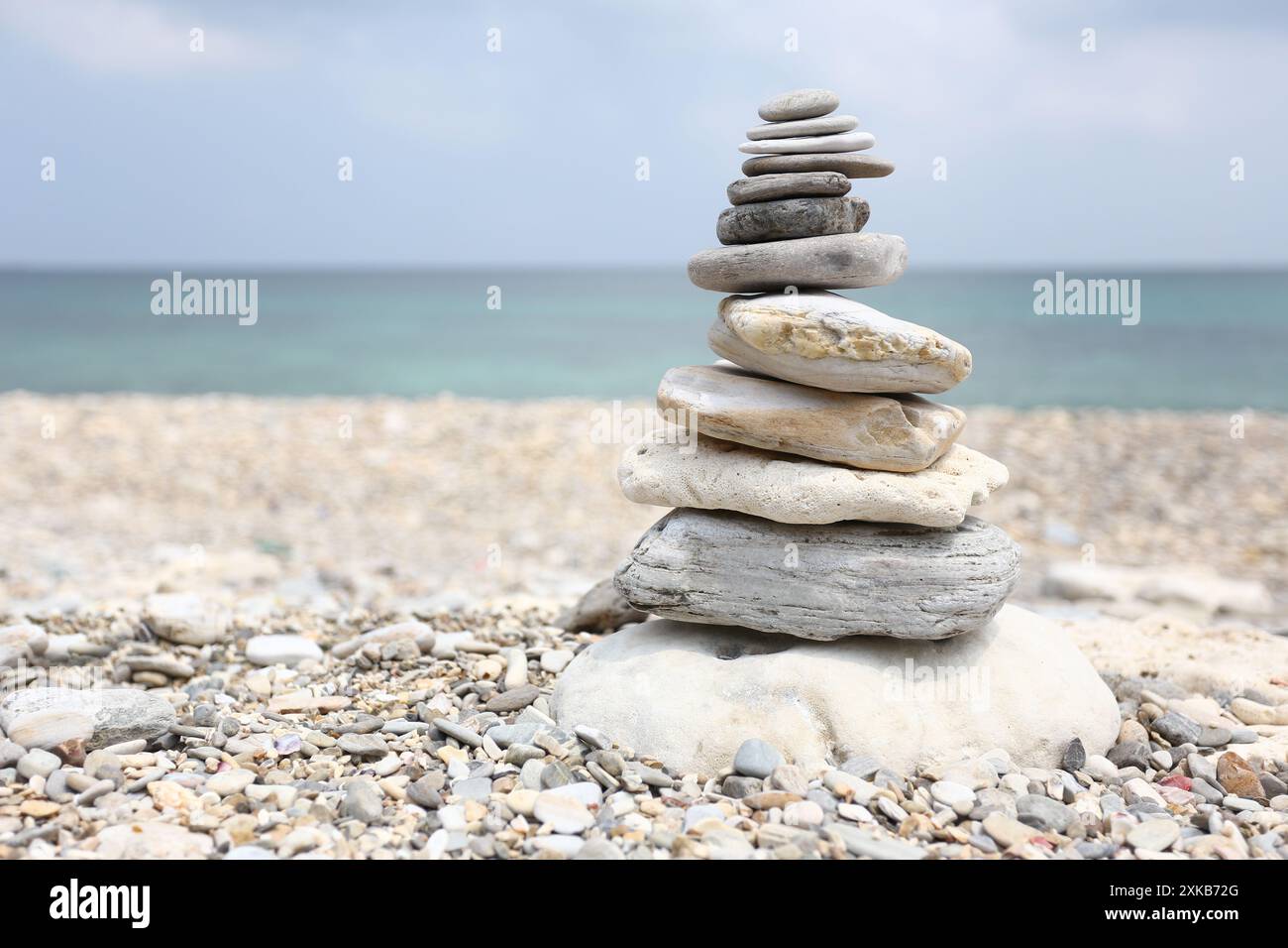 Sandstone are stacked into a pyramid shape on sea and cloud background ...