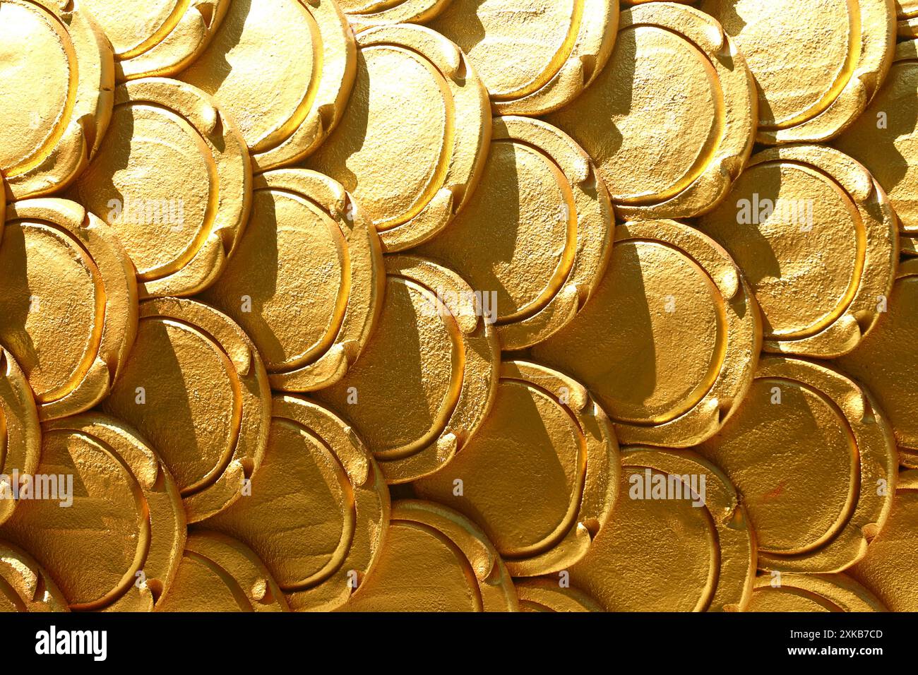 Gold patterns of stucco shaped like fish scales, Background of stacked ...