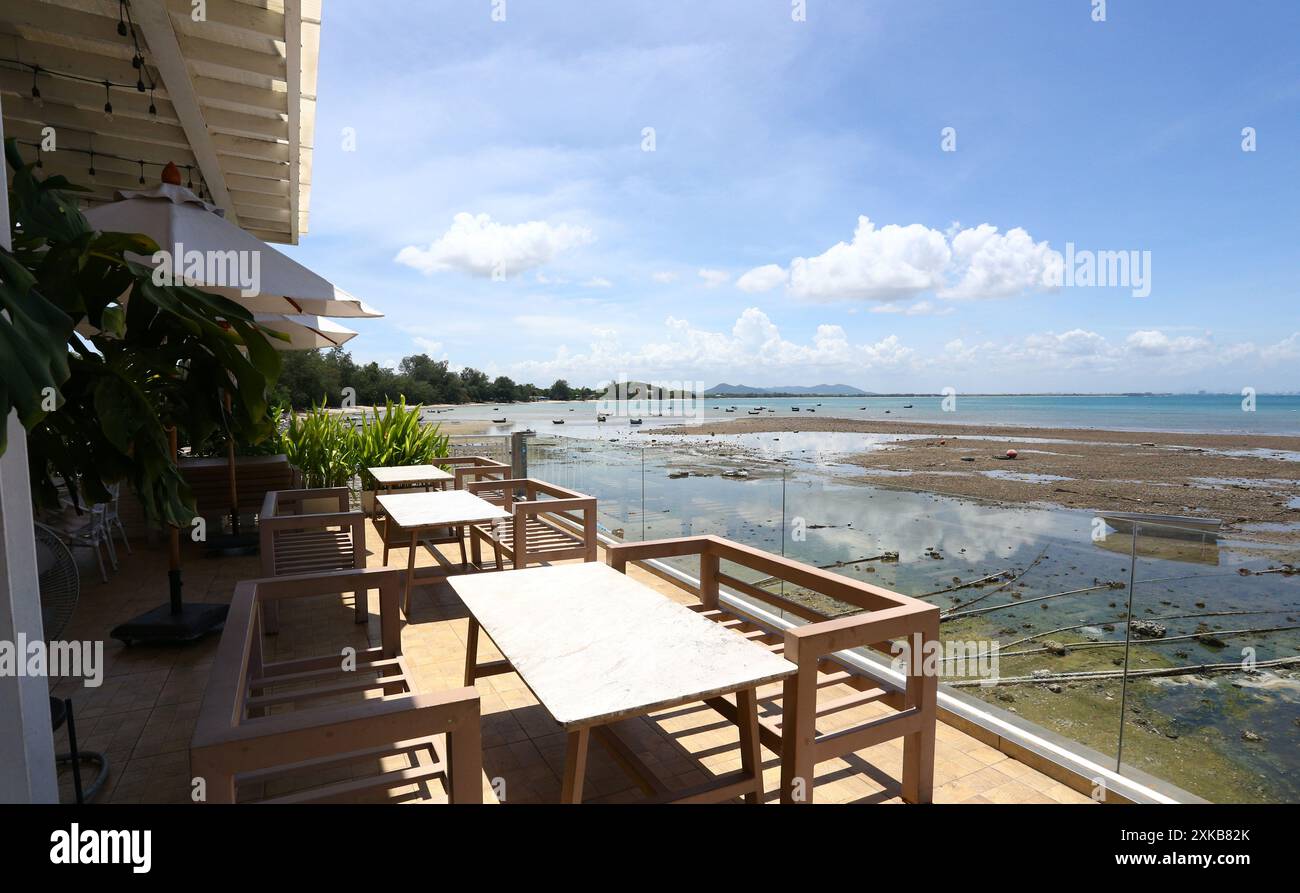 A table for eating in a dry coastal restaurant overlooking the sand ...