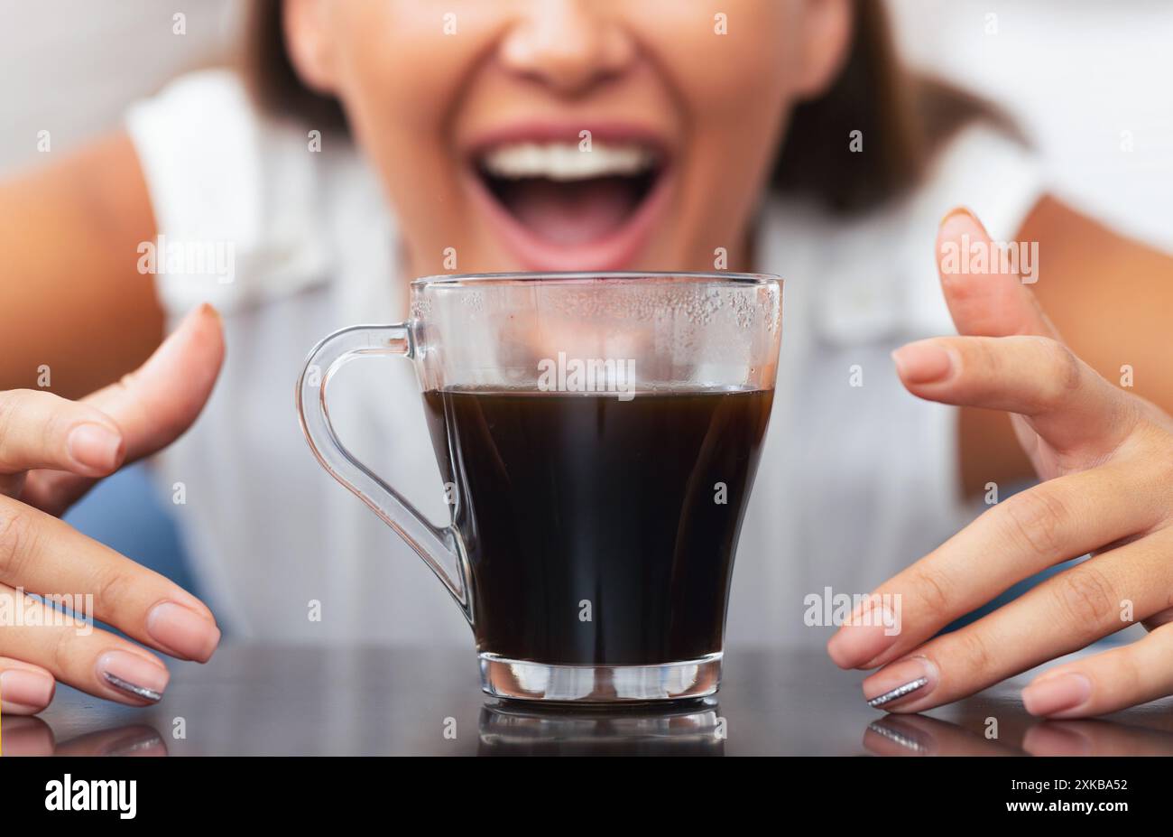 Girl Reaching For Cup Of Coffee Indoor, Cropped Stock Photo - Alamy