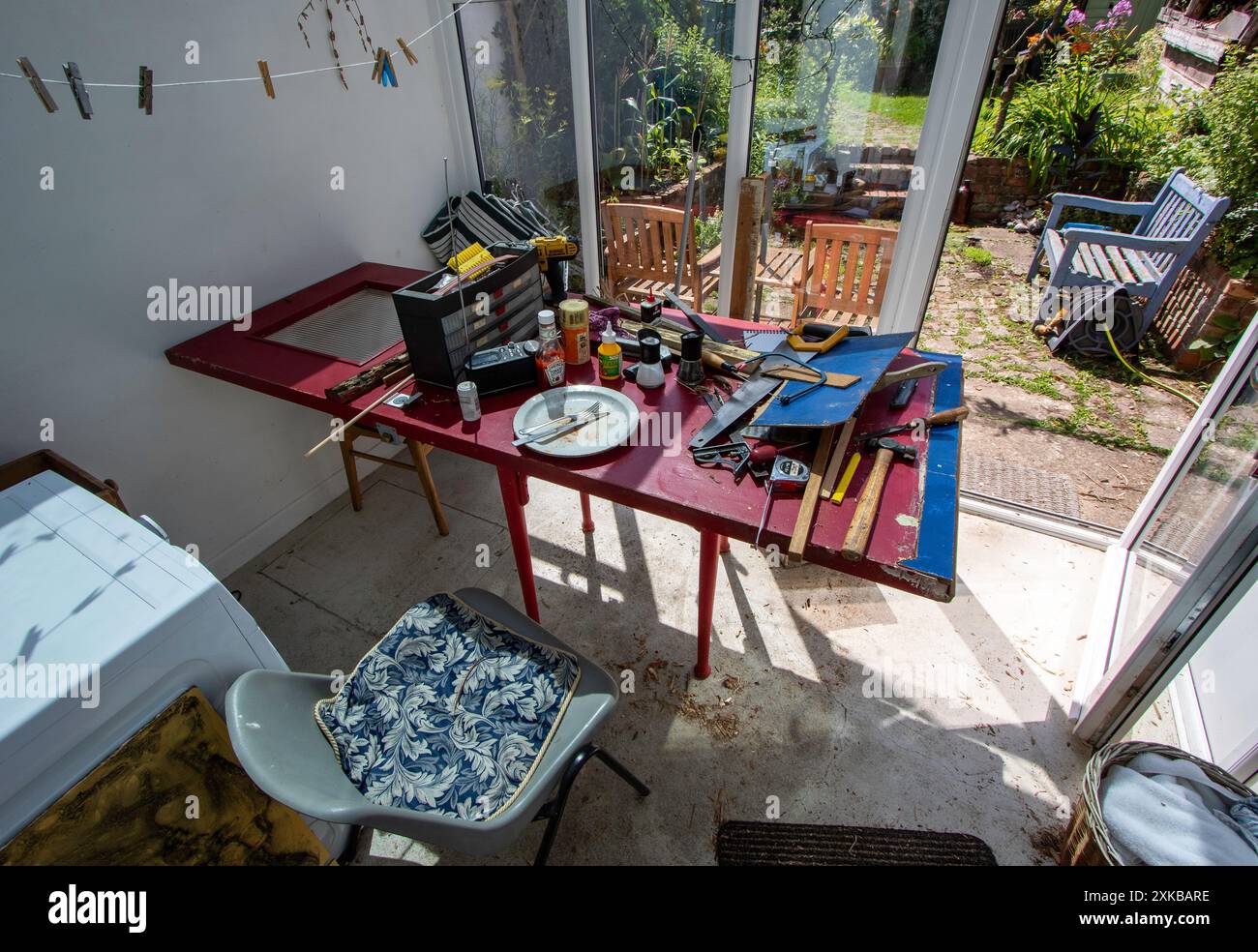 Improvised table top to eat breakfast on adark red door being repaired ...