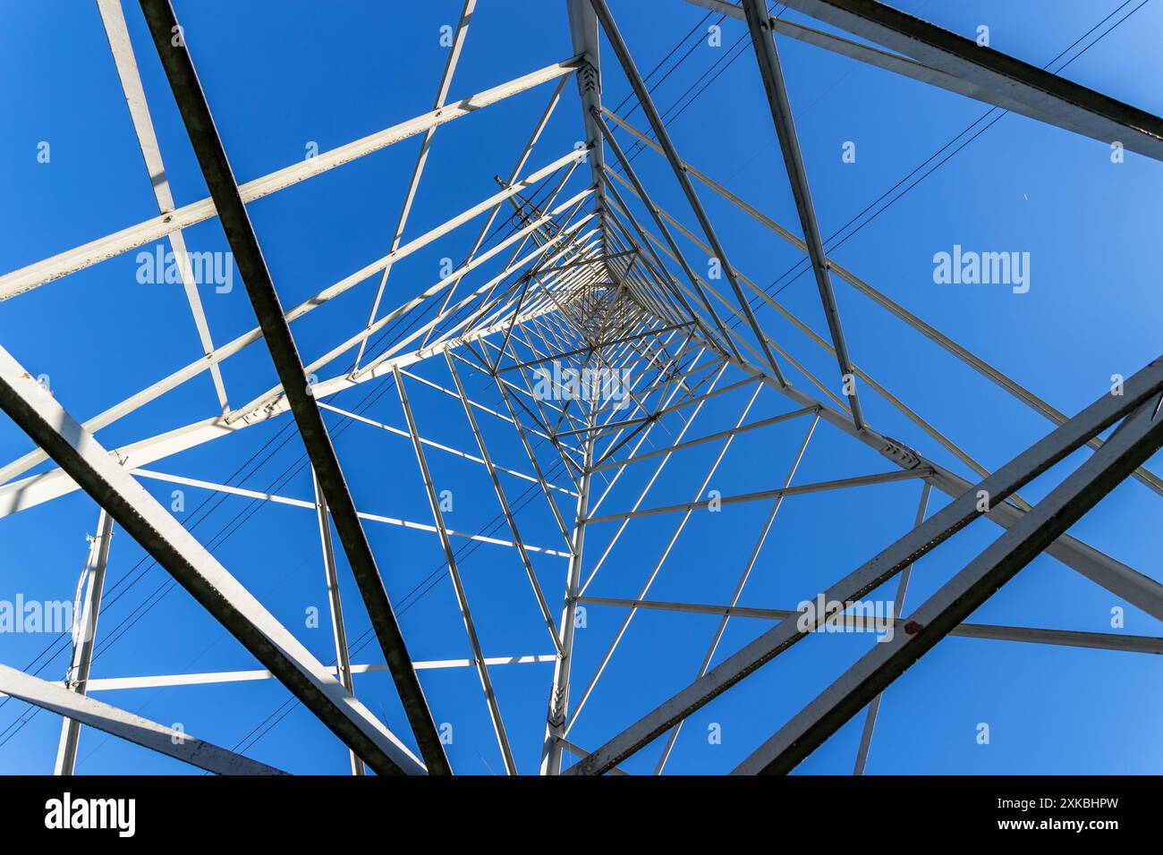 High Voltage Electricity Grid Pylon seen from below and blue sky Stock ...
