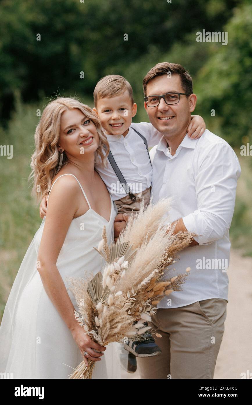 happy family three dad mom and son on a walk in the woods Stock Photo ...