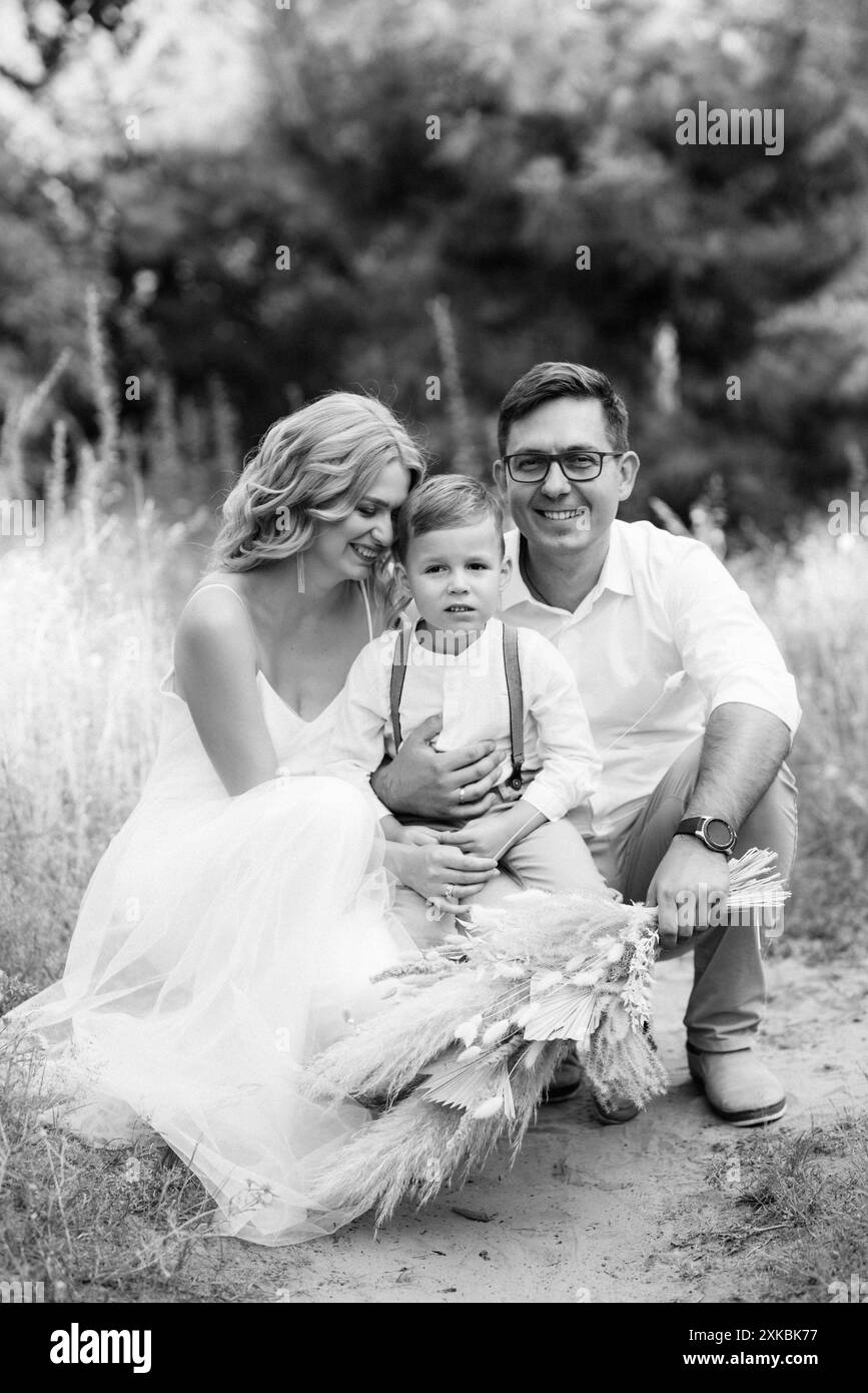 happy family three dad mom and son on a walk in the woods Stock Photo ...