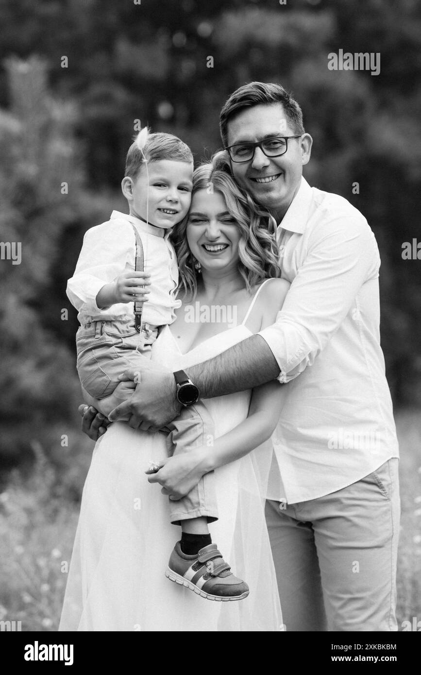 happy family three dad mom and son on a walk in the woods Stock Photo ...
