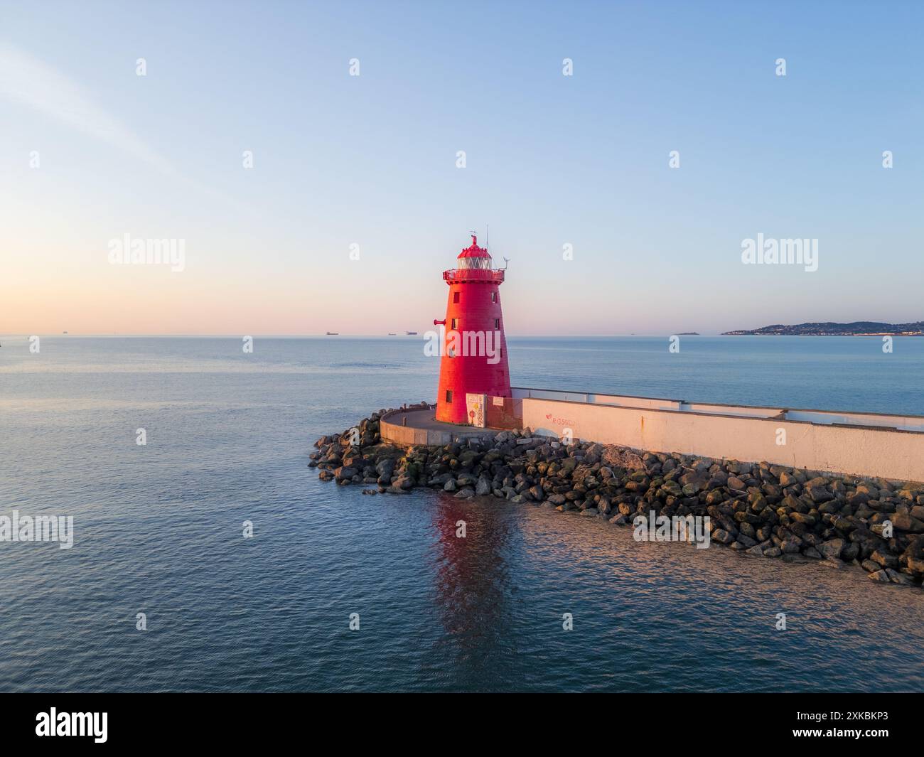 Sunrise side light reflecting on Poolbeg Lighthouse Stock Photo - Alamy