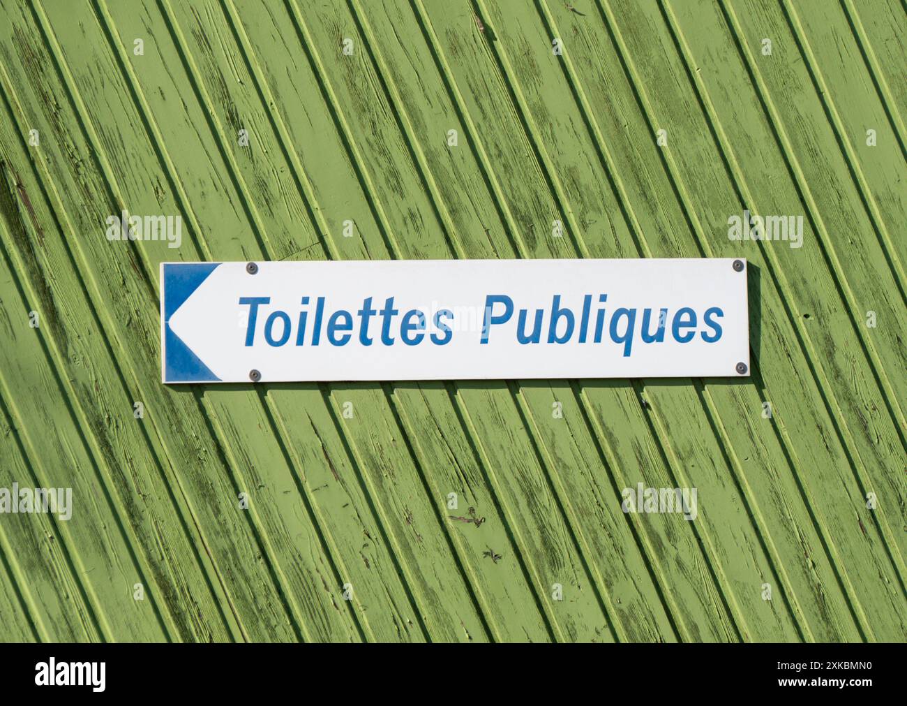 A public toilets sign on a wall guides for convenience and sanitation ...