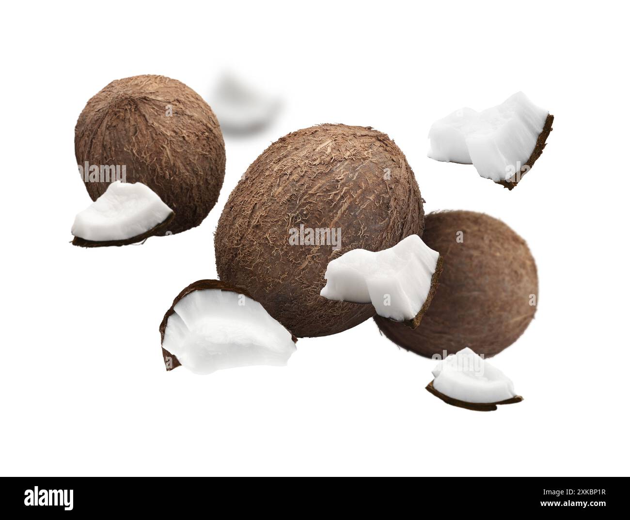 Many coconuts in air on white background Stock Photo - Alamy