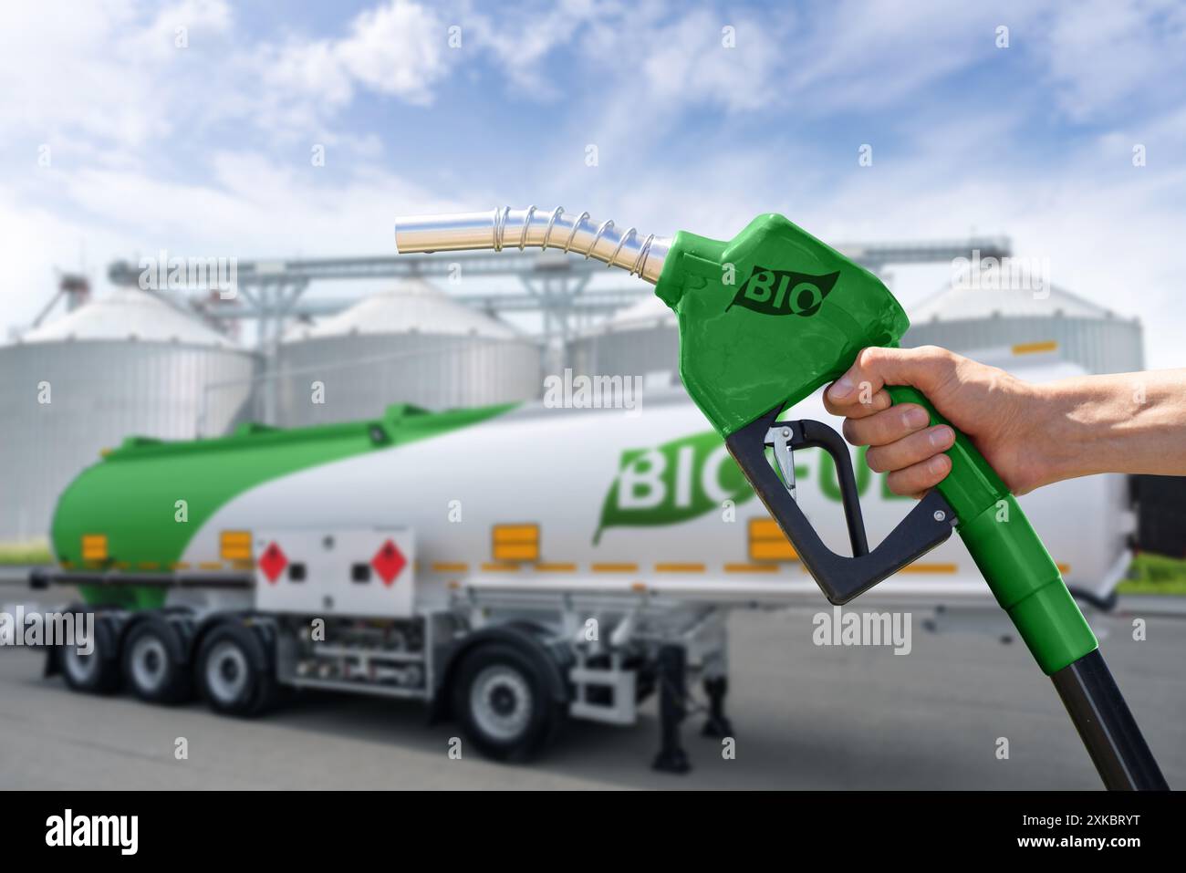 Hand with fuel nozzle with inscription BIO on a background of tank ...