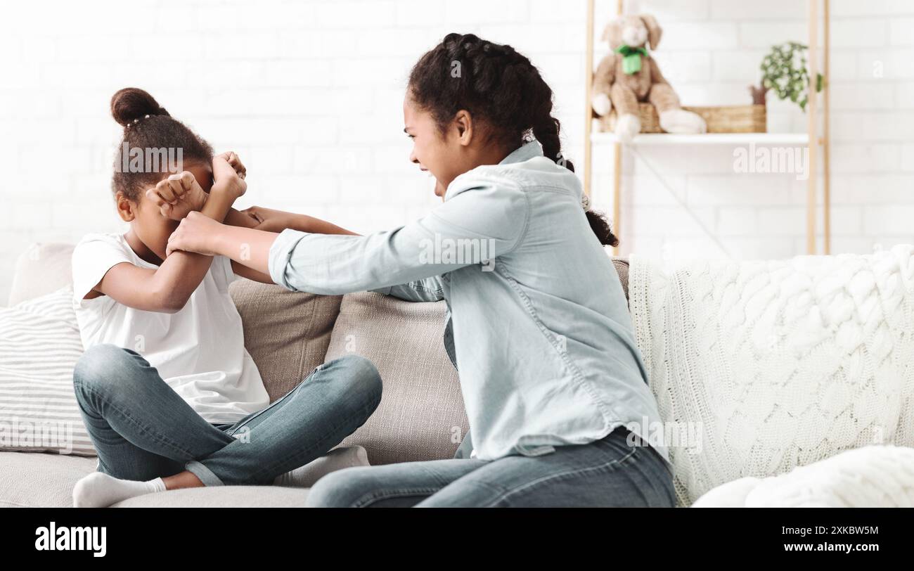 Two teenaged girls fighting at living room Stock Photo - Alamy