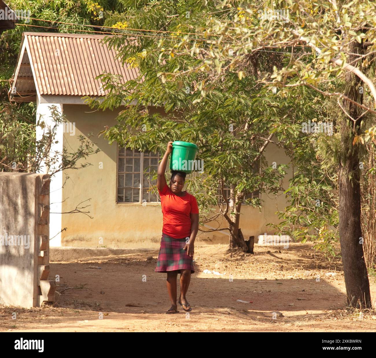 Girl carrying water, School grounds, St Louis Secondary School for ...