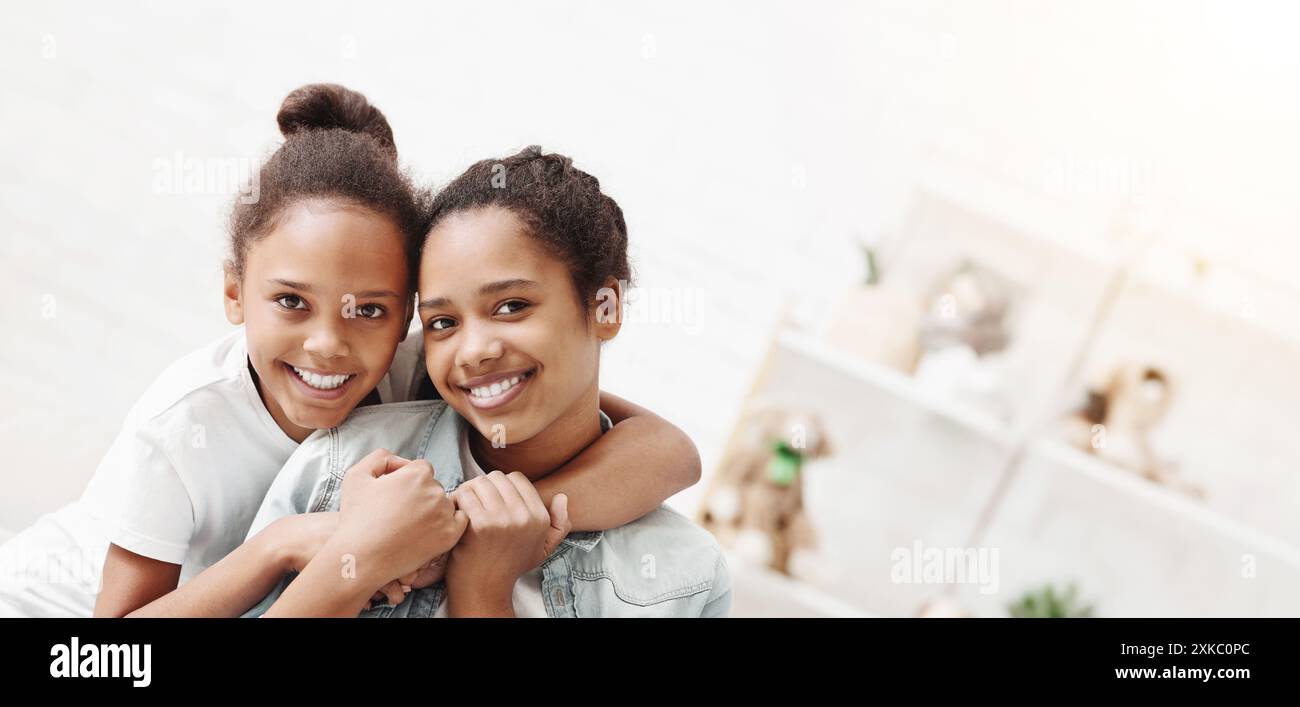 Portrait of two lovely african sisters bonding at home Stock Photo - Alamy