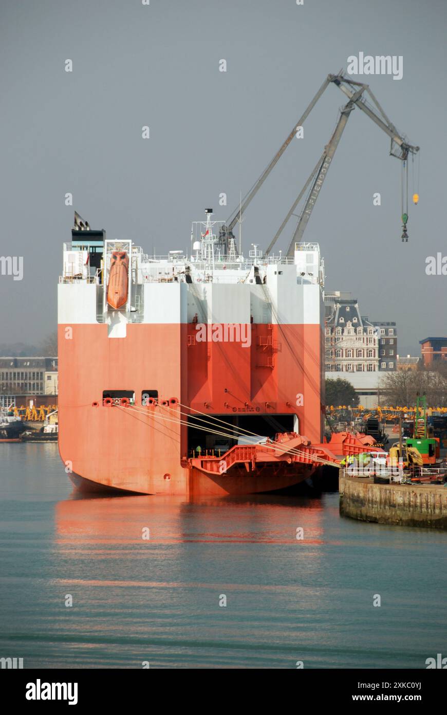 Ship on a quayside being loaded Stock Photo - Alamy