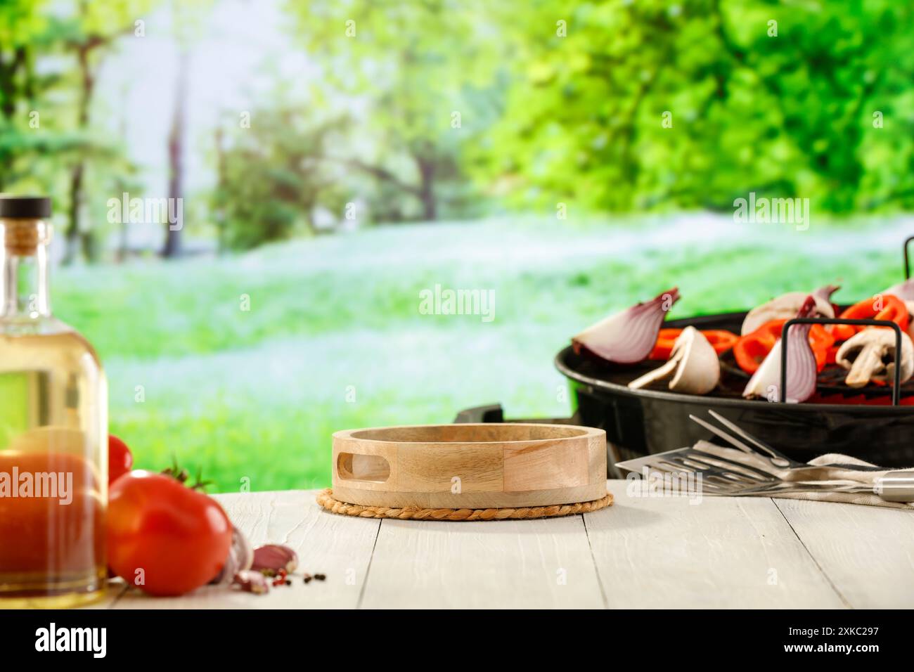 Grilling in garden concept. Red vegetables on wooden board table with ...