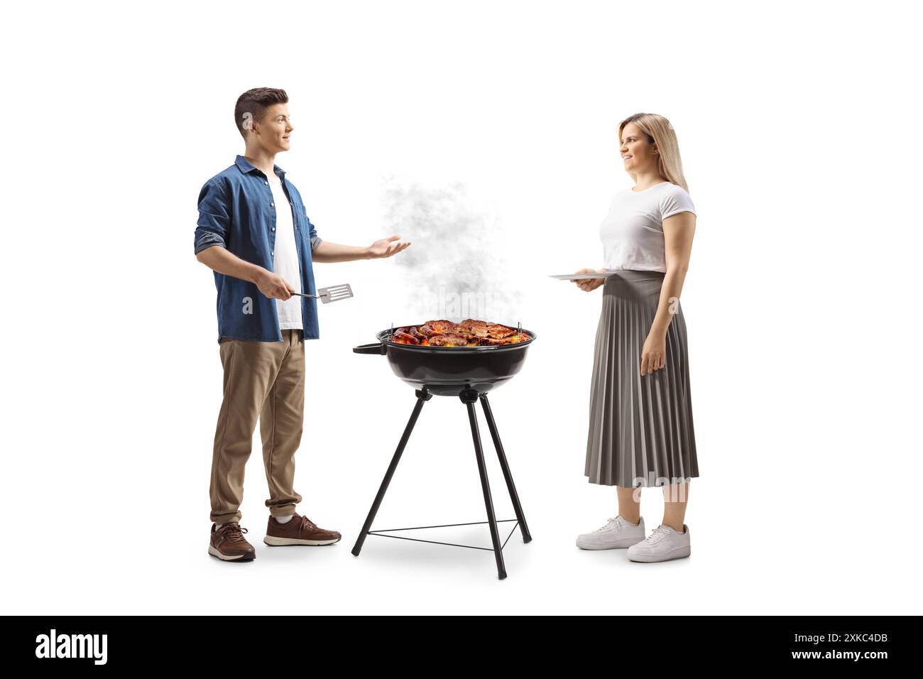 Young man and woman making a bbq and talking isolated on white ...