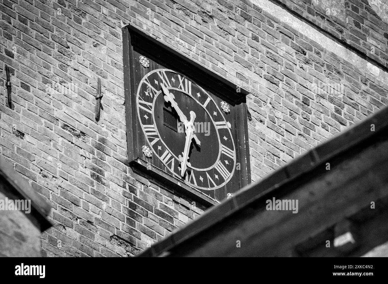 A wall clock on a brick building Stock Photo - Alamy