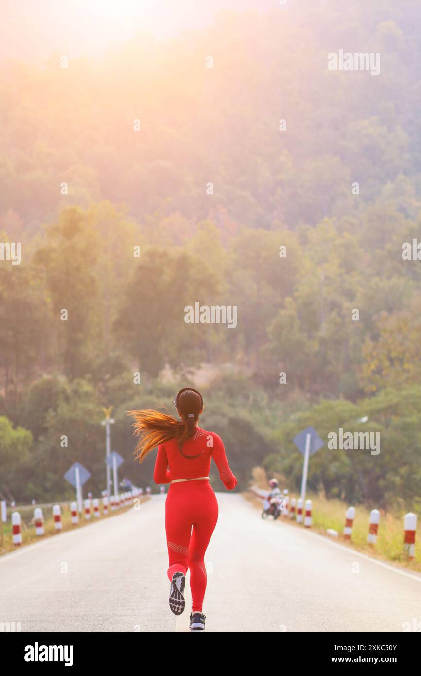 Blurred image, young woman in sportswear jogging in morning to ...