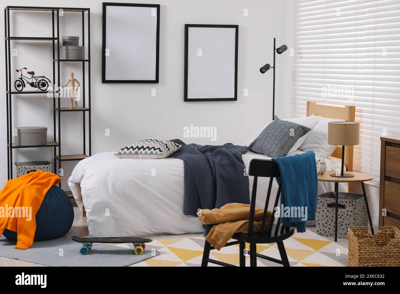 Teen's room interior with modern furniture and empty frames on wall ...