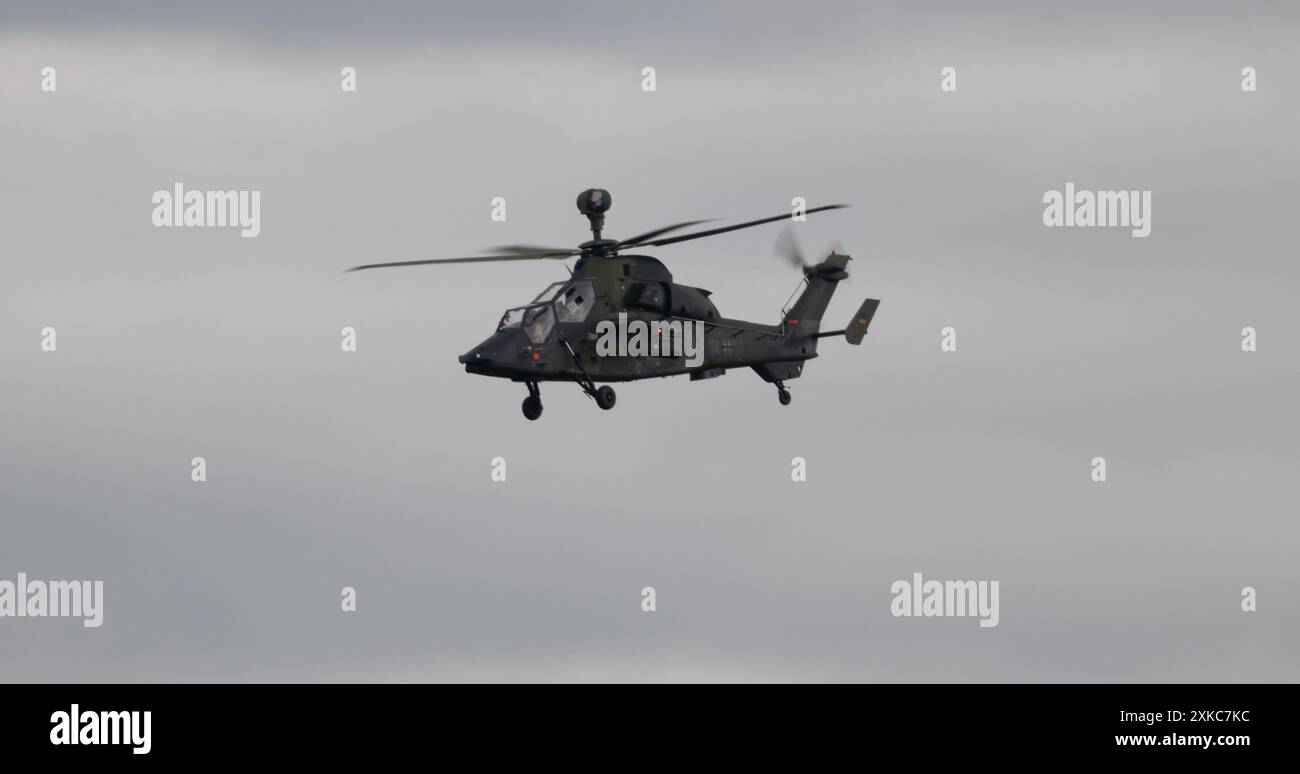 A military helicopter is flying in the clear blue sky, demonstrating ...