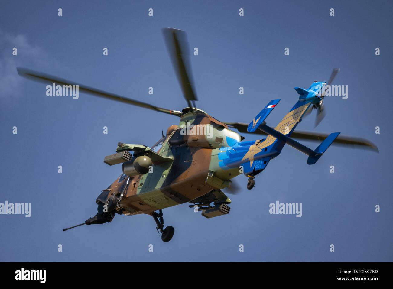 A military helicopter is flying in the clear blue sky, demonstrating ...