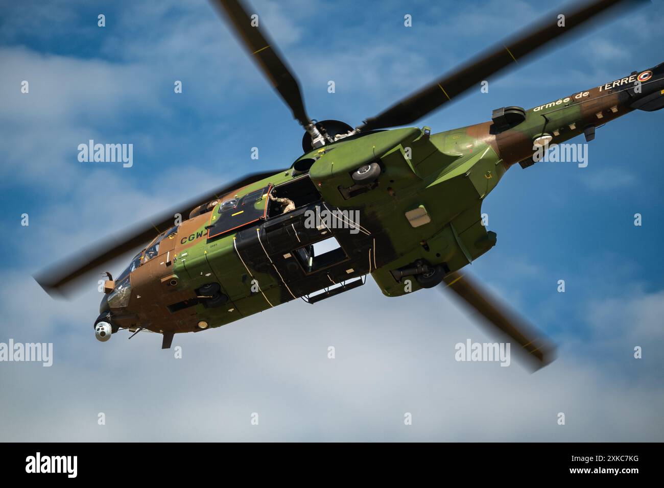 A military helicopter is flying in the clear blue sky, demonstrating ...