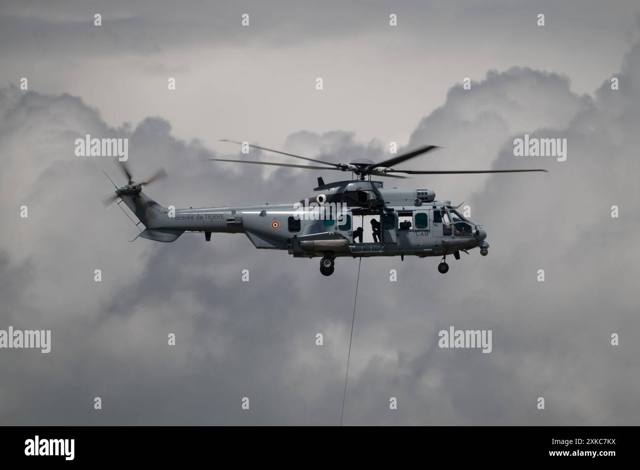 A military helicopter is flying in the clear blue sky, demonstrating ...