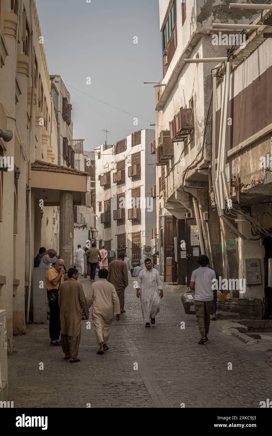 Saudi people on the streets of historic Jeddah (Al Balad), with the ...