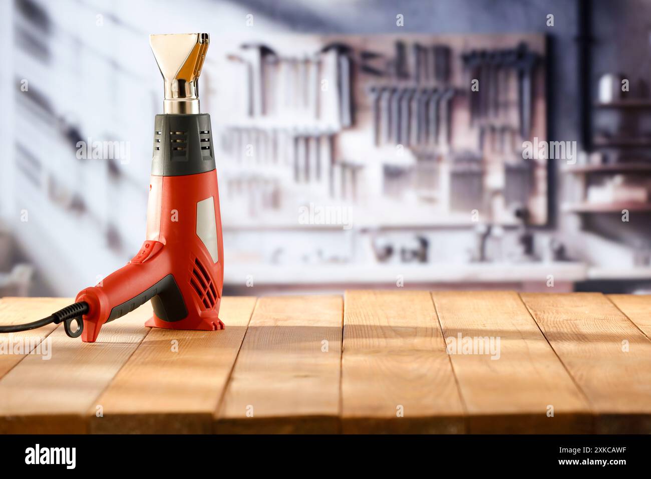 Heat gun tool blow torch on wooden work table in craft workshop ...