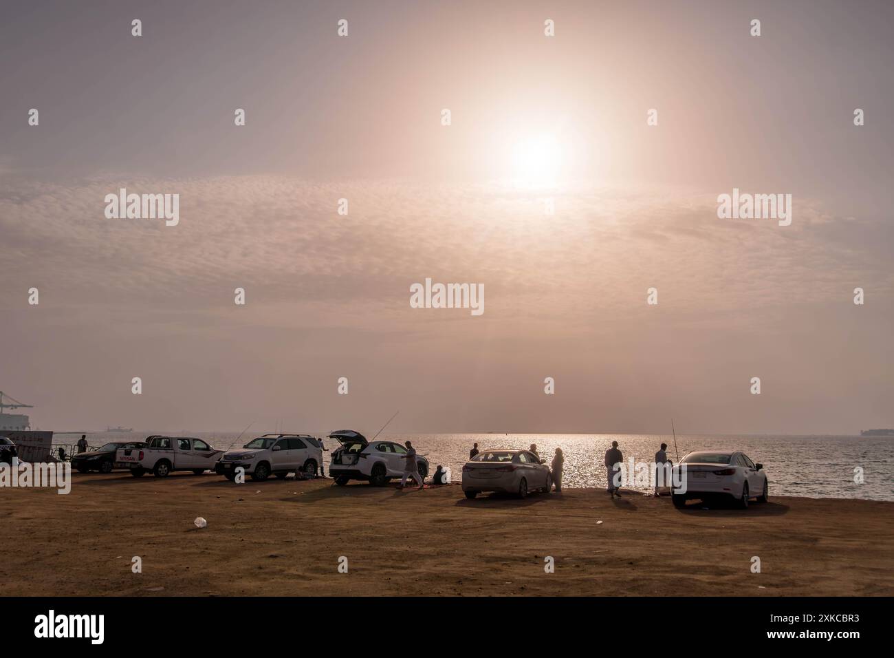 Arab people with cars watching sunset on the Red Sea coast in Jeddah ...